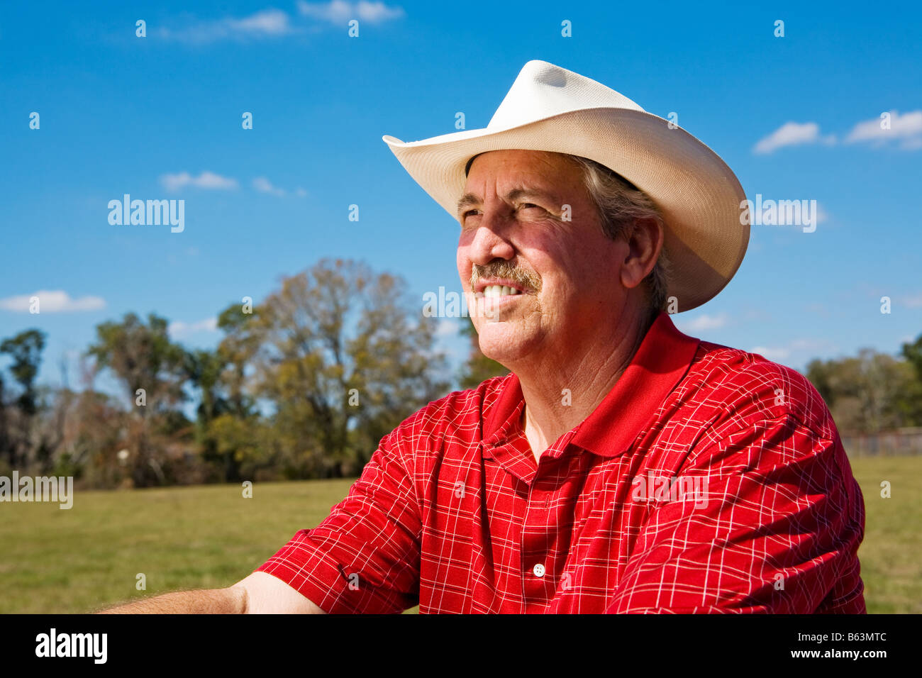 Portrait of a mature cowboy on his ranch looking to the future Stock ...