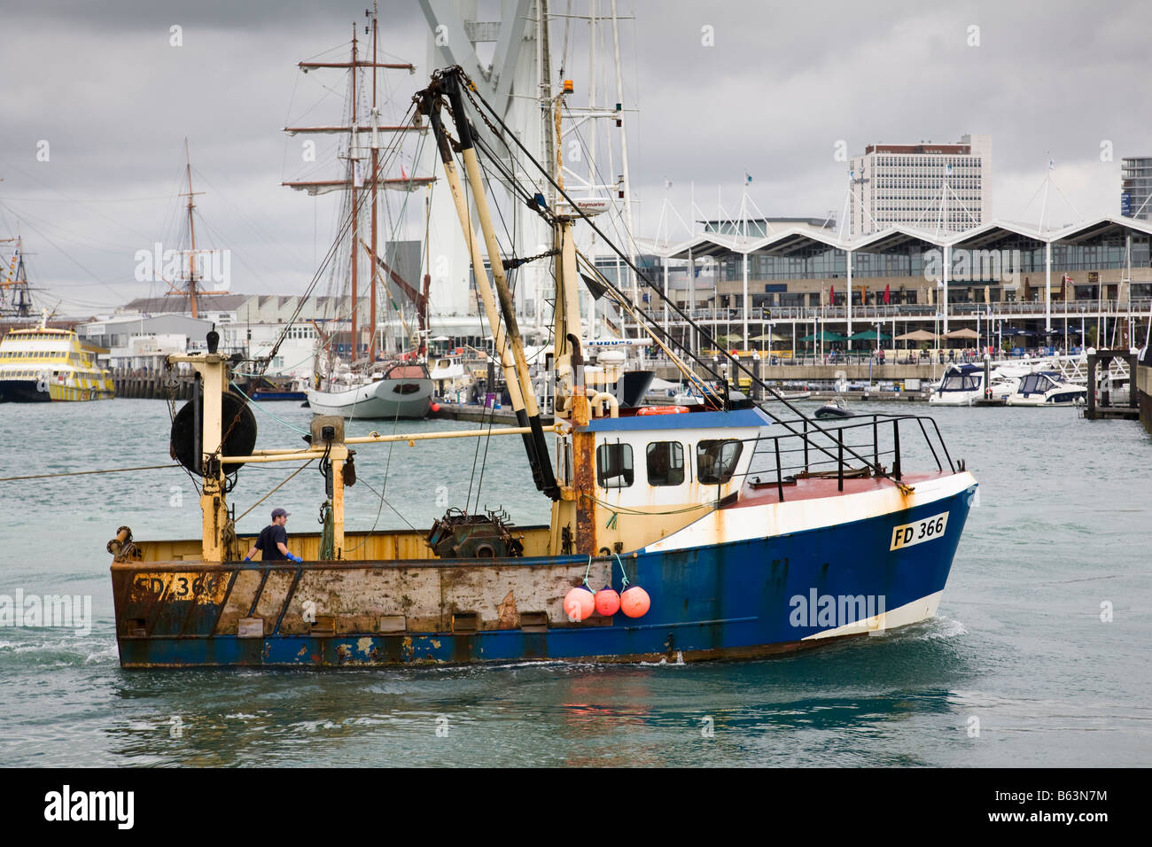 A fishing boat tows another out of sight round Portsmouth Point on ...