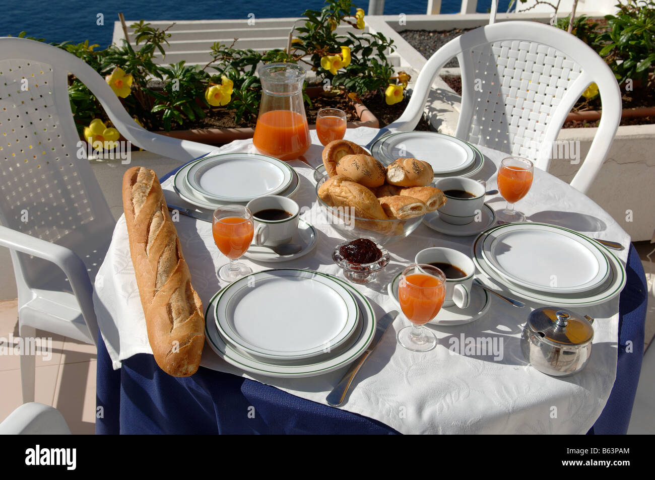 Breakfast table laid out patio villa - Mediterranean Stock Photo - Alamy