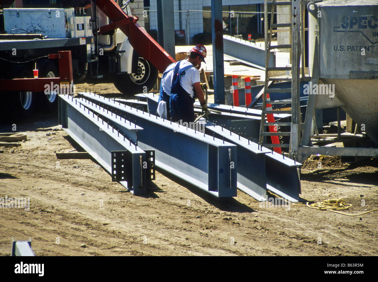 Worker prepares steel beams for addition to construction project Stock ...