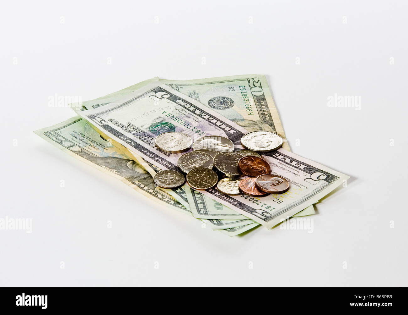 Pile of US currency notes and coins loosely laid out on the table Stock ...