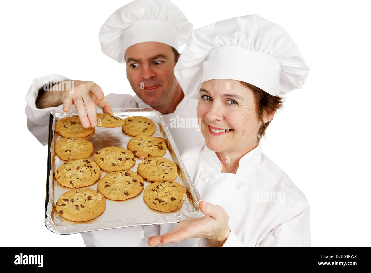 One chef sneakes up and steals a chocolate chip cookie from another ...