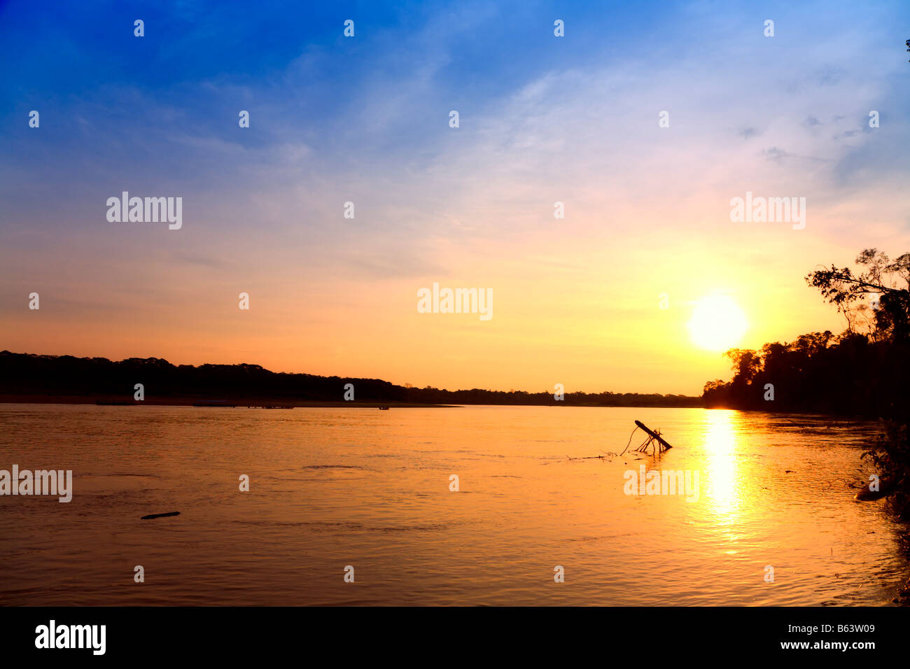 Sunset over Manu River Stock Photo - Alamy