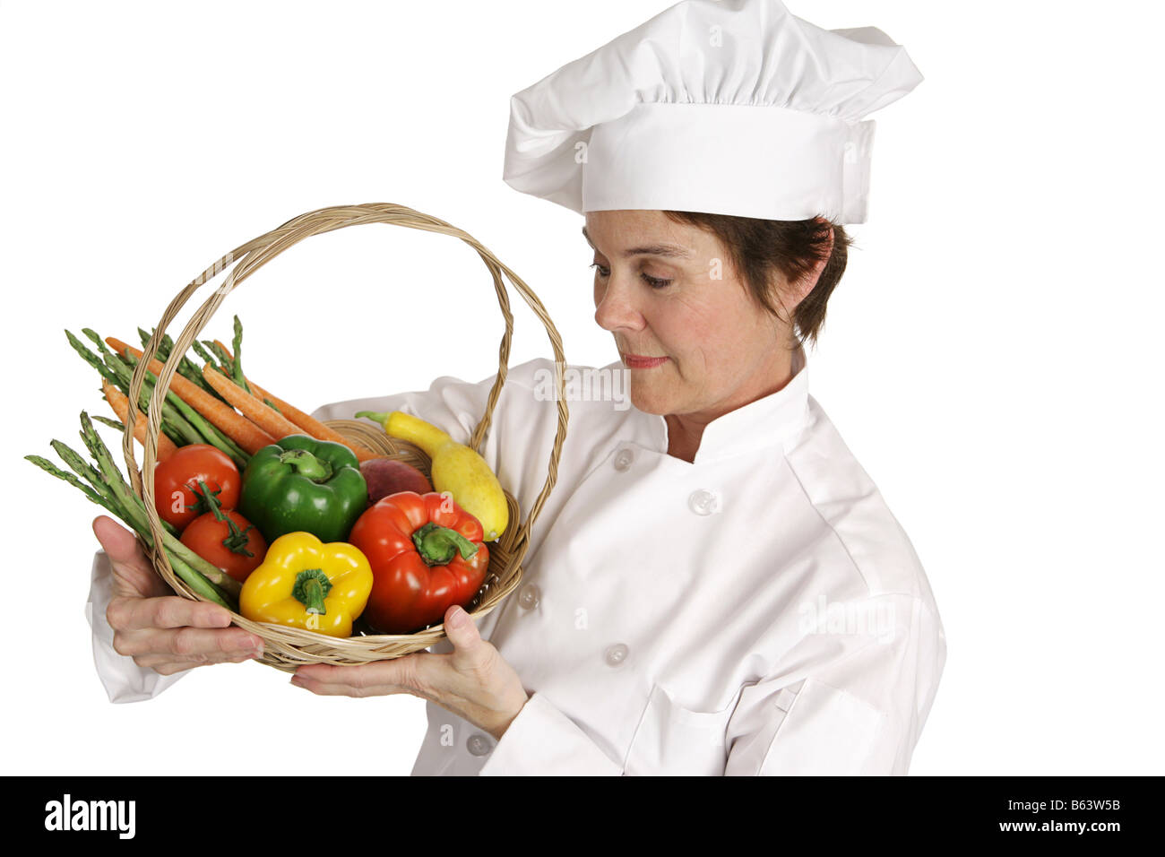 A chef inspecting a basket of fresh vegetables Isolated on white Stock ...