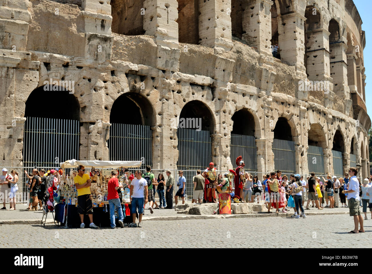 A street trader sell fake brand goods to tourists by the Colosseum and ...