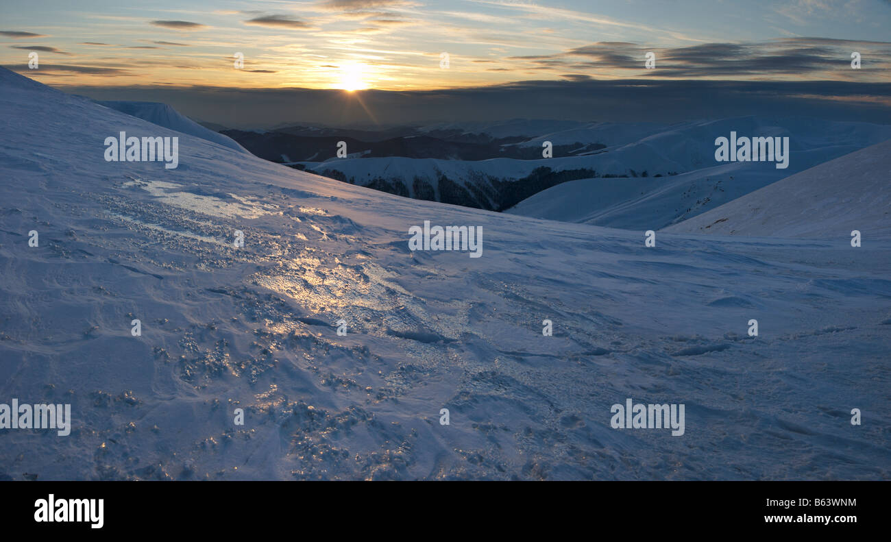 Beautiful mountain sunset landscape with sun way on ice coated ...