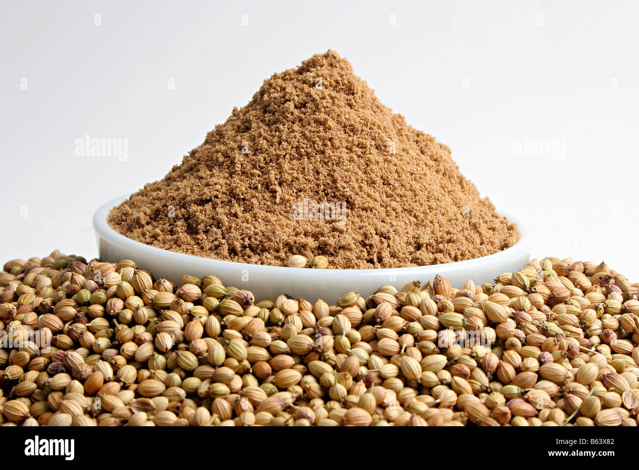 Piles of Dhania (Coriander seed), with Bowl full of Dhania Powder ...