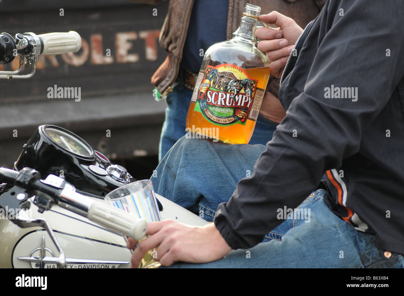 Man on motorbike drinking alcohol Stock Photo - Alamy