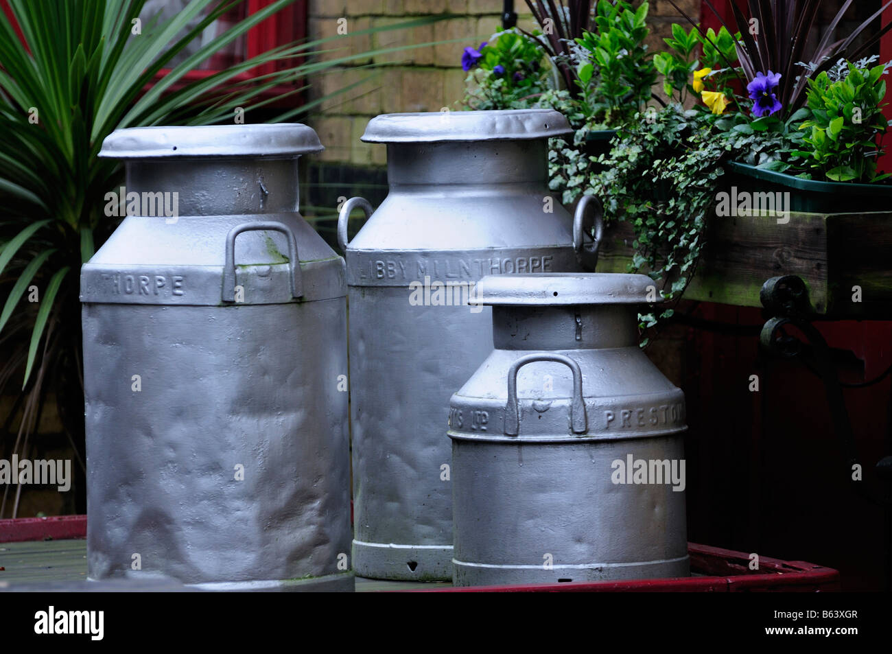 Three old milk churns Stock Photo - Alamy