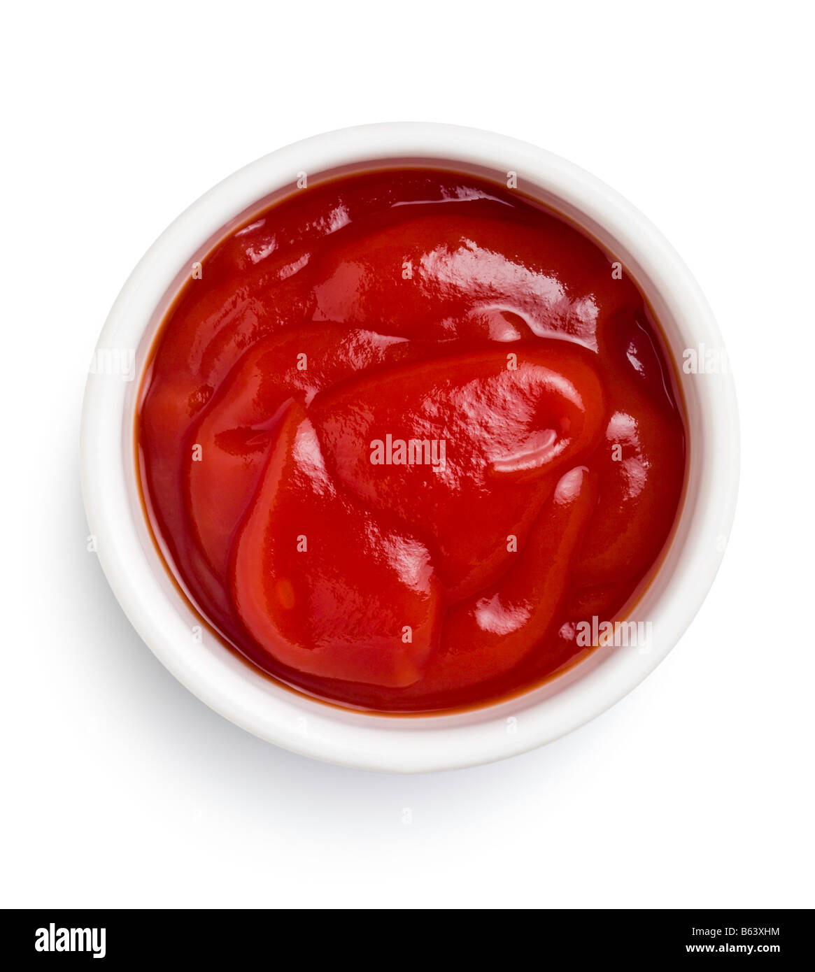 Close up of tomato ketchup in a white dish isolated on a white ...