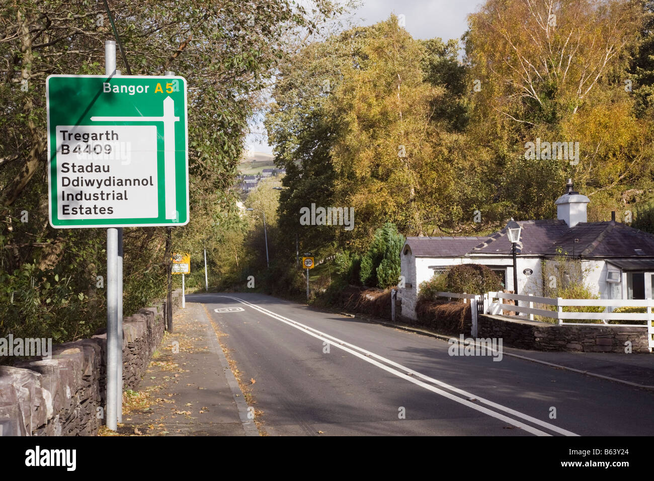A5 road and sign by old Turnpike Cottage on historic route built by ...