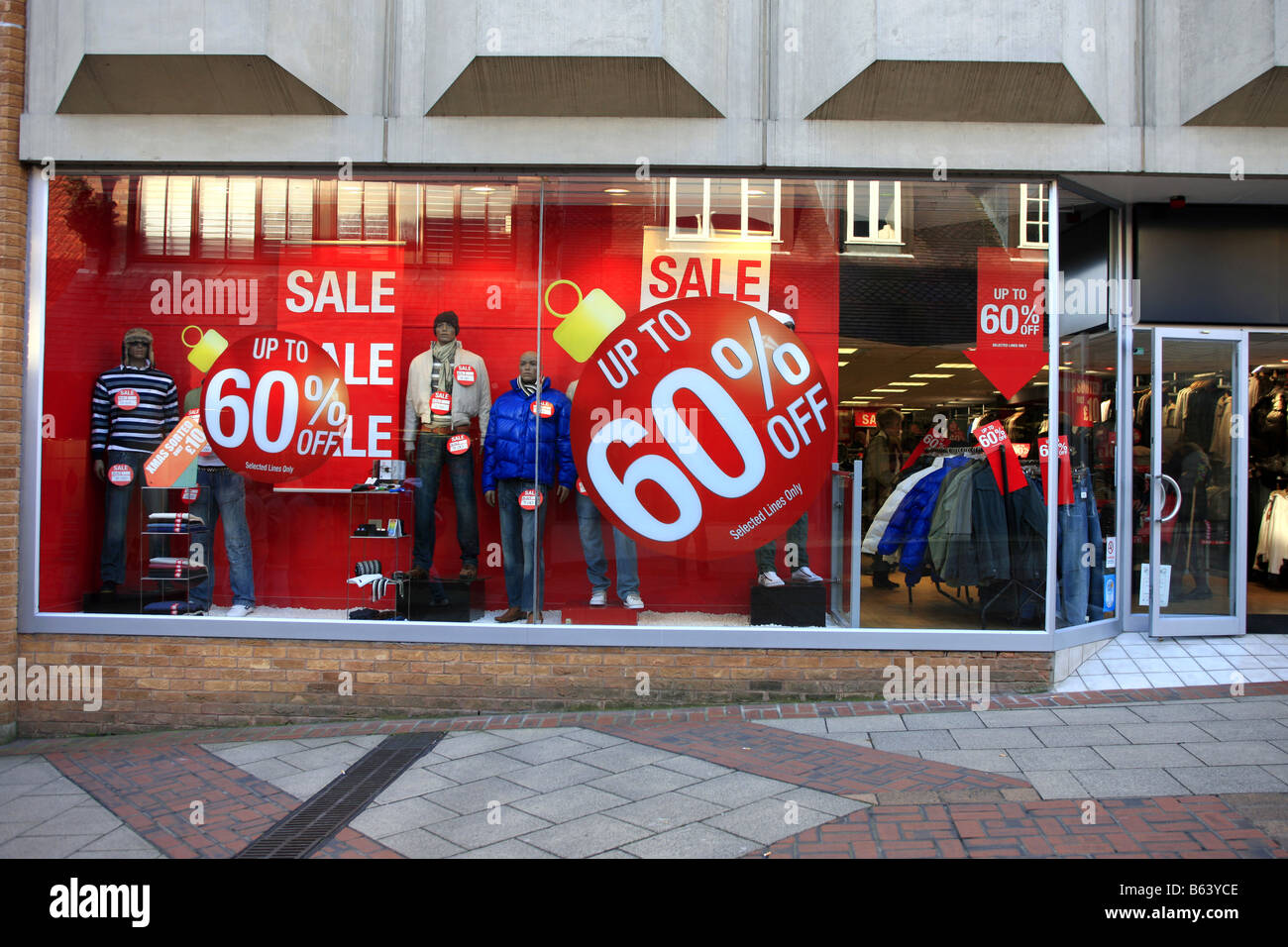 Savings posters in the window of a high street store trying to entice ...