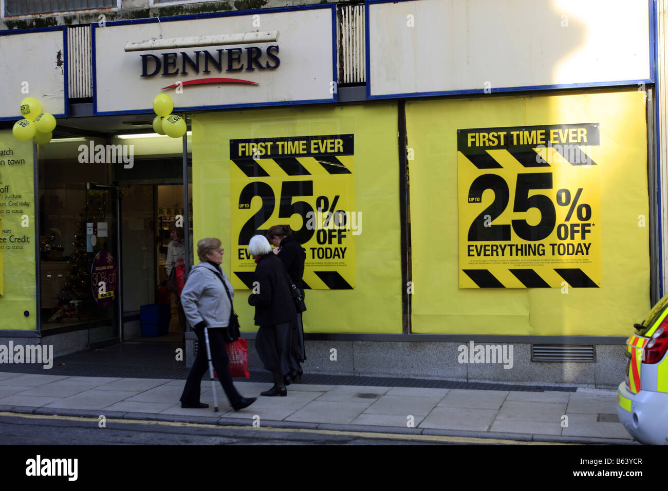Savings posters in the window of a high street store trying to entice ...