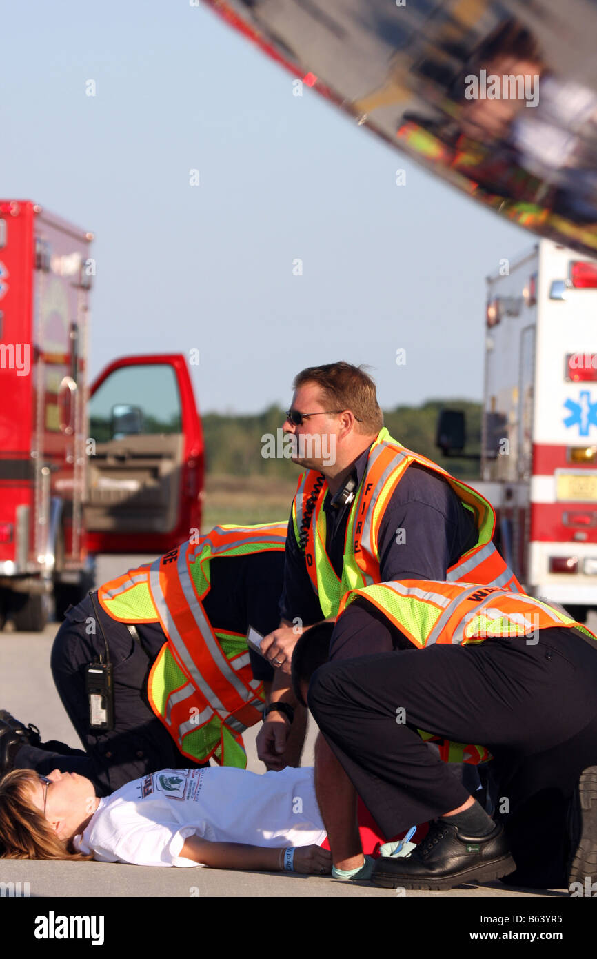 Three EMS personnel helping an injured women at a mass casualty ...