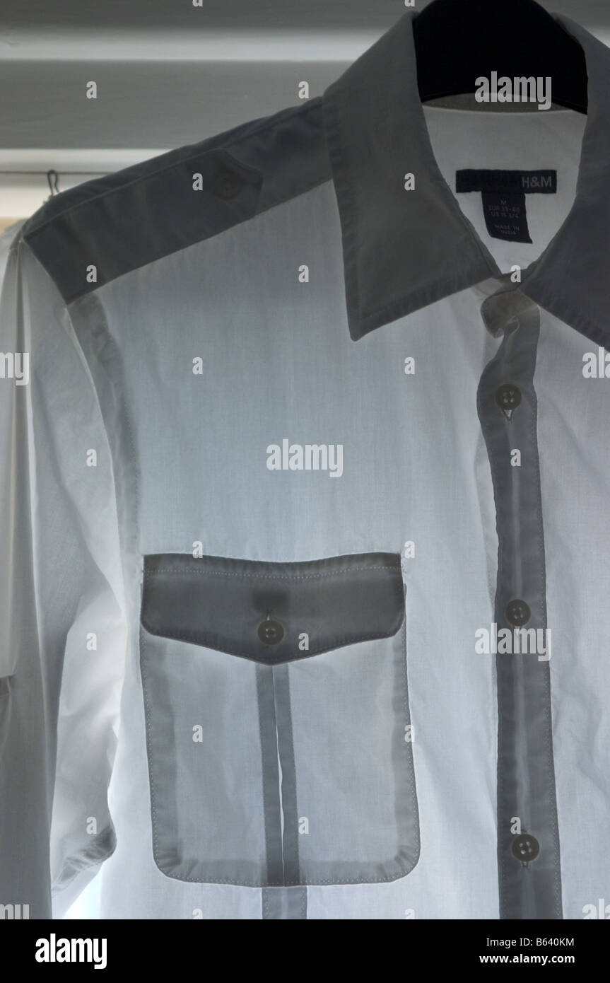 White shirt on hanger, see through Stock Photo - Alamy