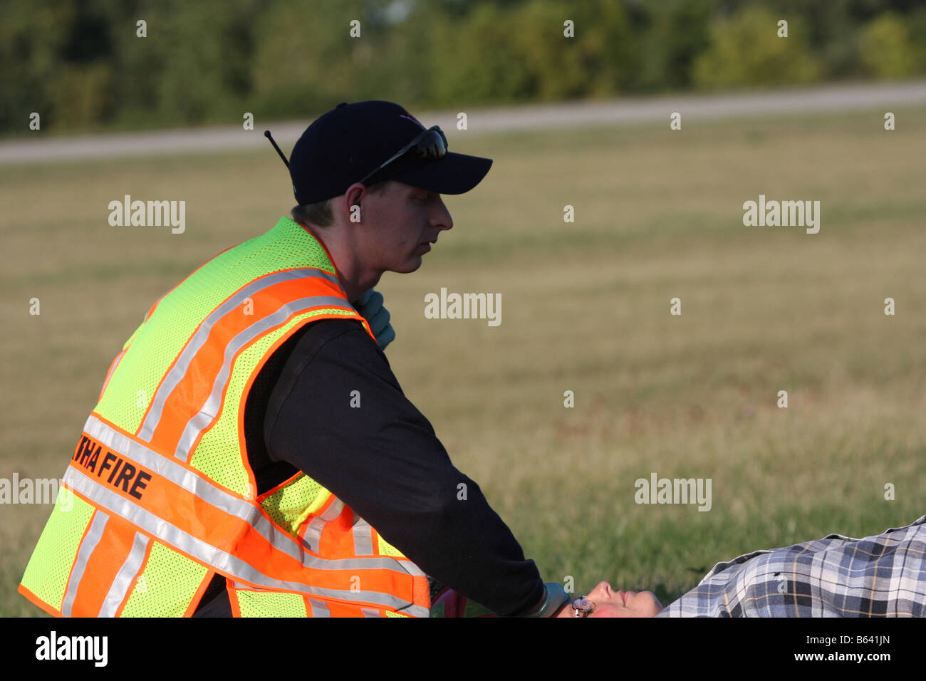 An EMS personnel checking an injured woman at a mass casualty incident ...