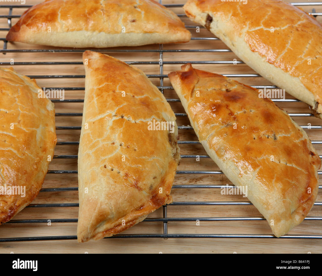 Home made pasties cooling on a wire rack Stock Photo - Alamy