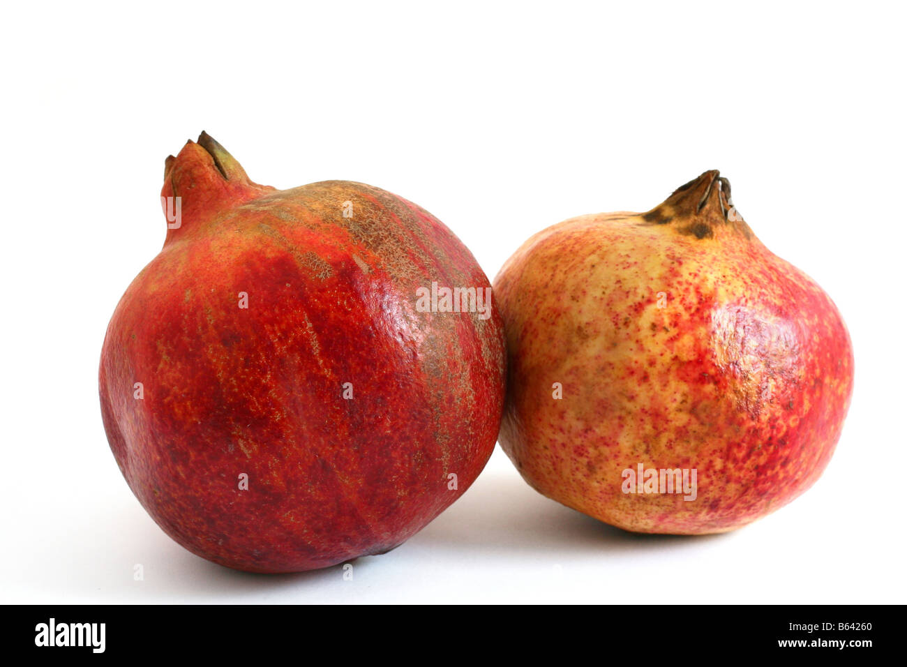 Two whole pomegranates - studio shot, white background Stock Photo - Alamy