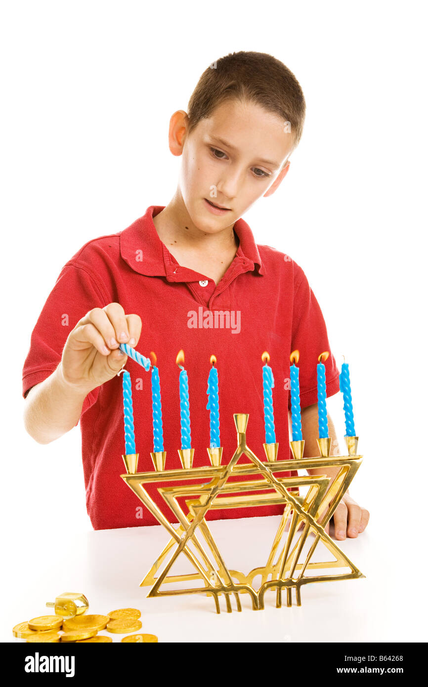 Young boy lighting the menorah for Hanukkah Isolated on white Stock ...