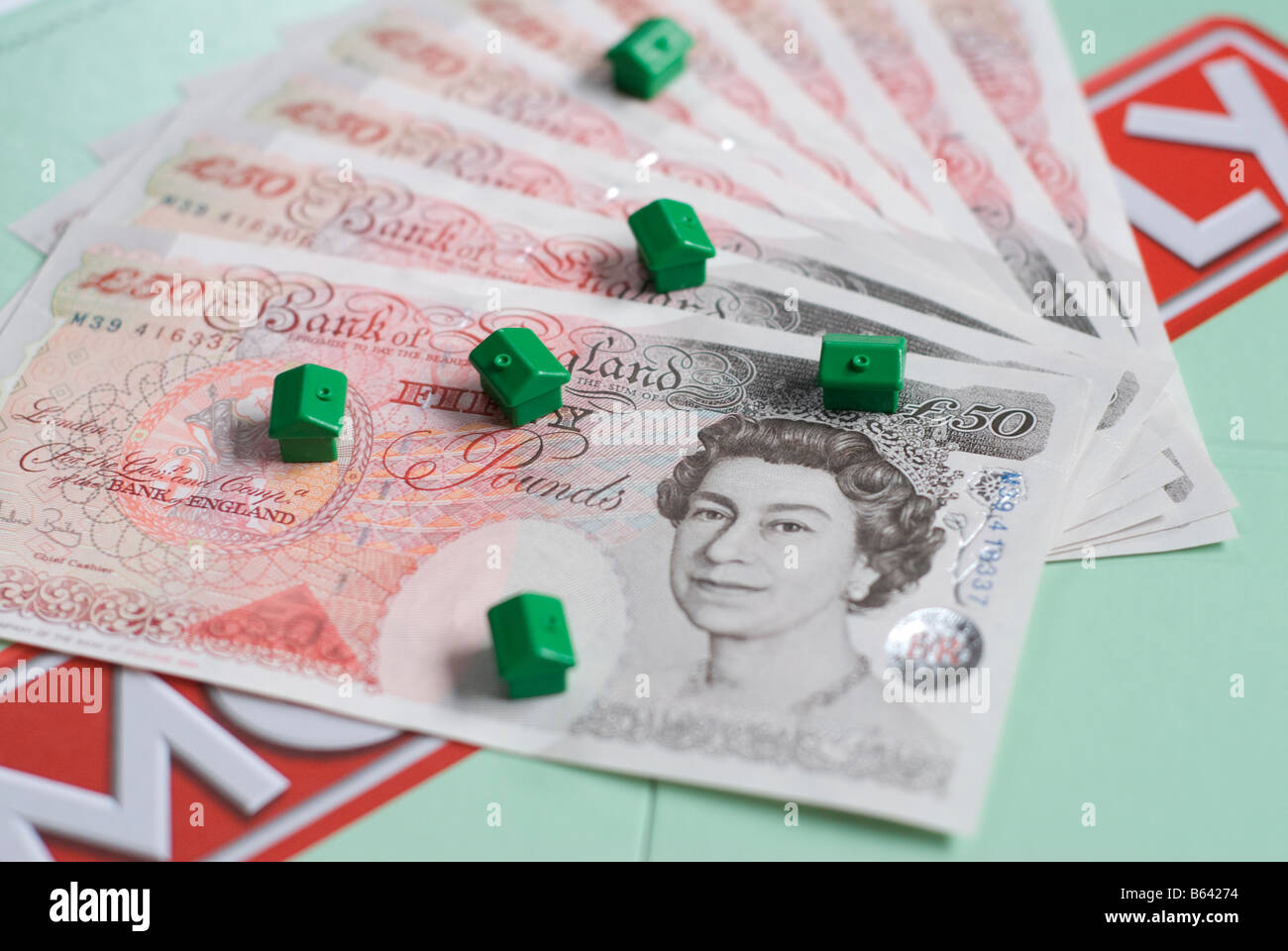 Pounds and houses on a Monopoly board game Stock Photo - Alamy