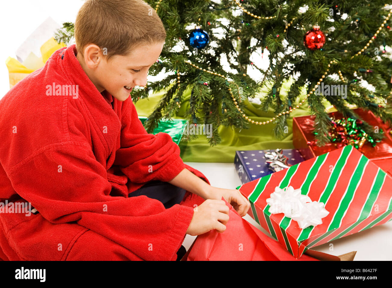 Cute little boy opening his presents on Christmas morning Stock Photo ...