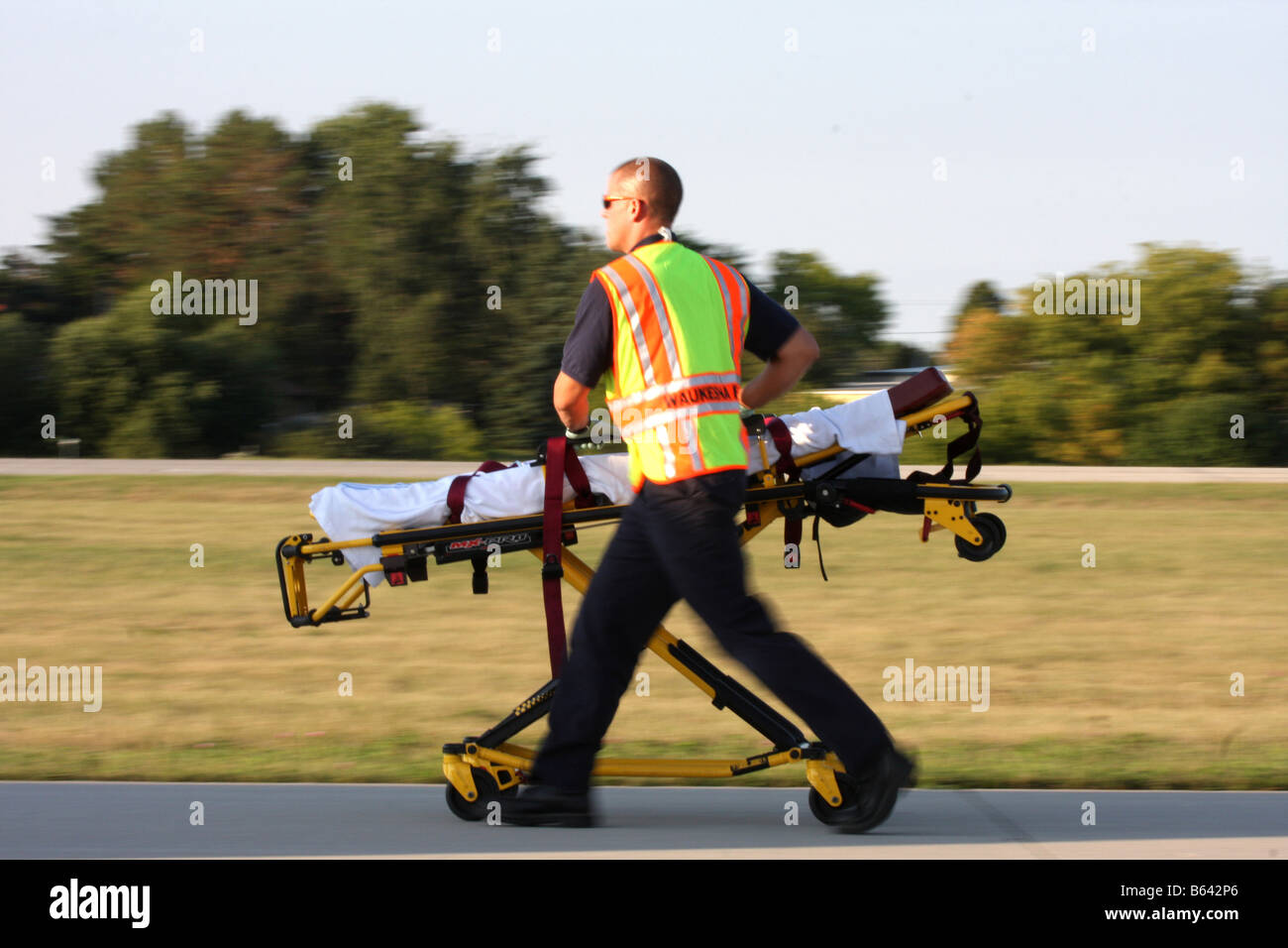 A Waukesha EMT running with the medical stretcher cot to the injured ...