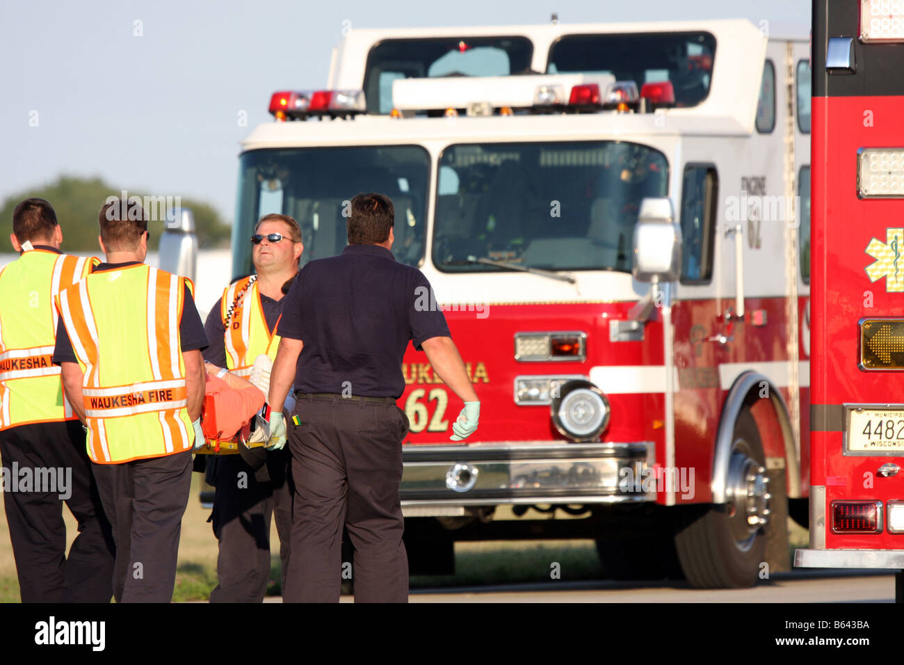 Four EMTs are carrying a patient to the ambulance Stock Photo - Alamy