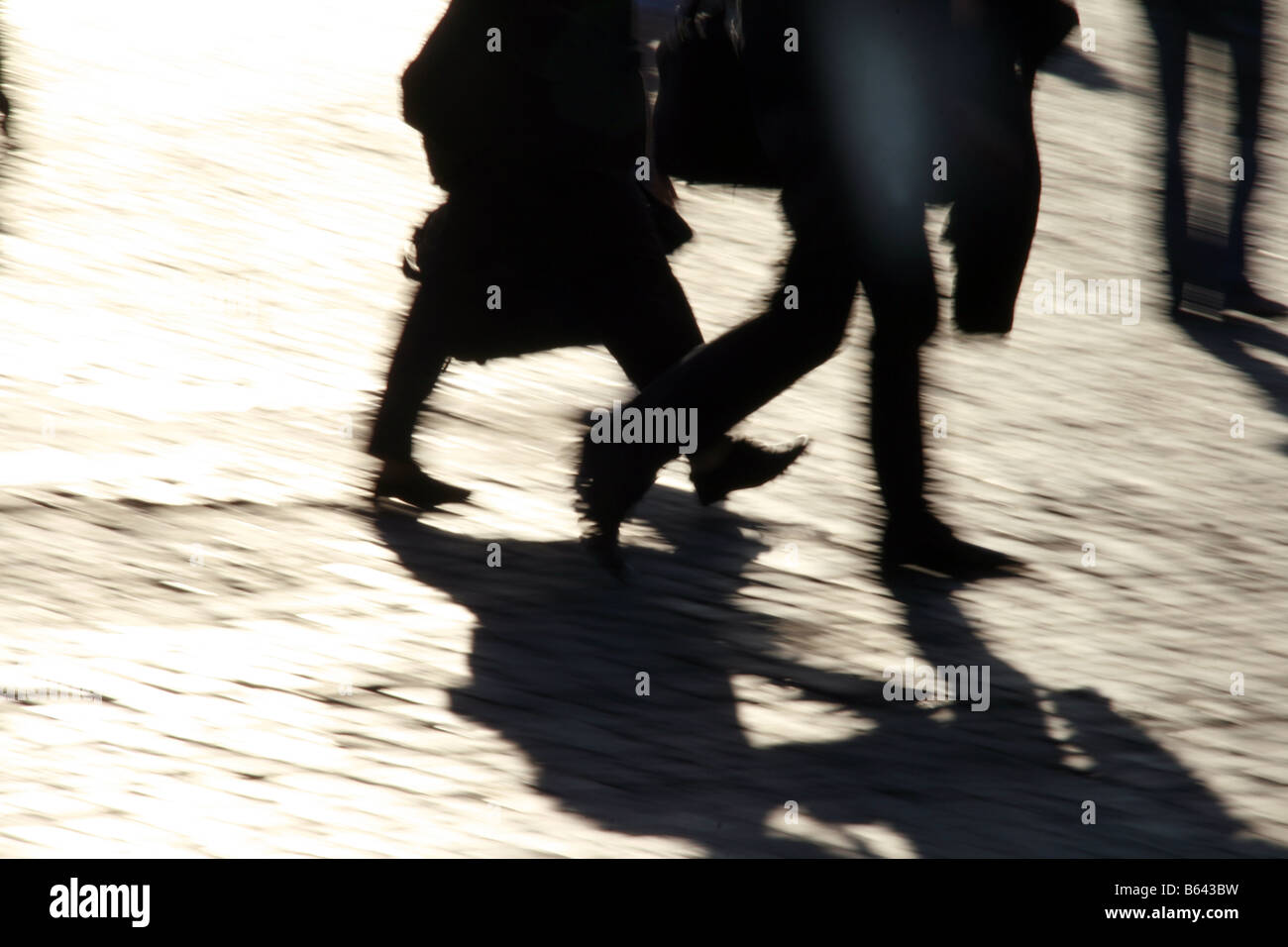 shadow people fast speed feet legs walking in sun in street in town ...