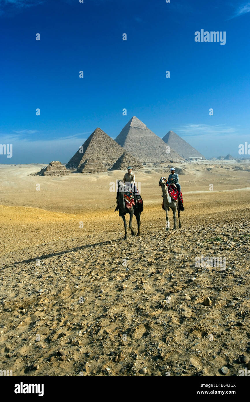 Egypt, Cairo, Pyramids at Giza (Gizeh), Man and tourist (woman) with ...