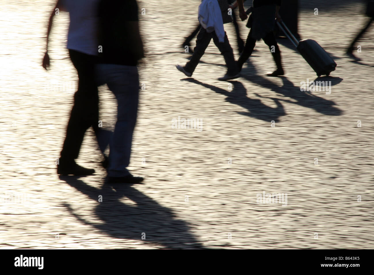 shadow people fast speed feet legs walking in sun in street in town ...