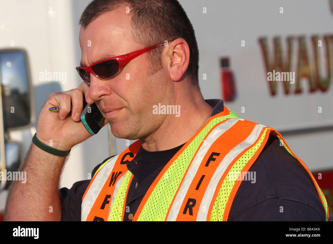 A paramedic on a cell phone Stock Photo - Alamy