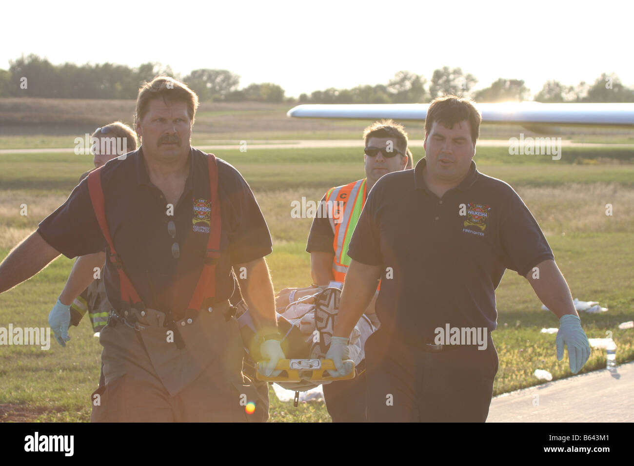 Paramedics carrying a patient a the scene of a mass casualty incident ...