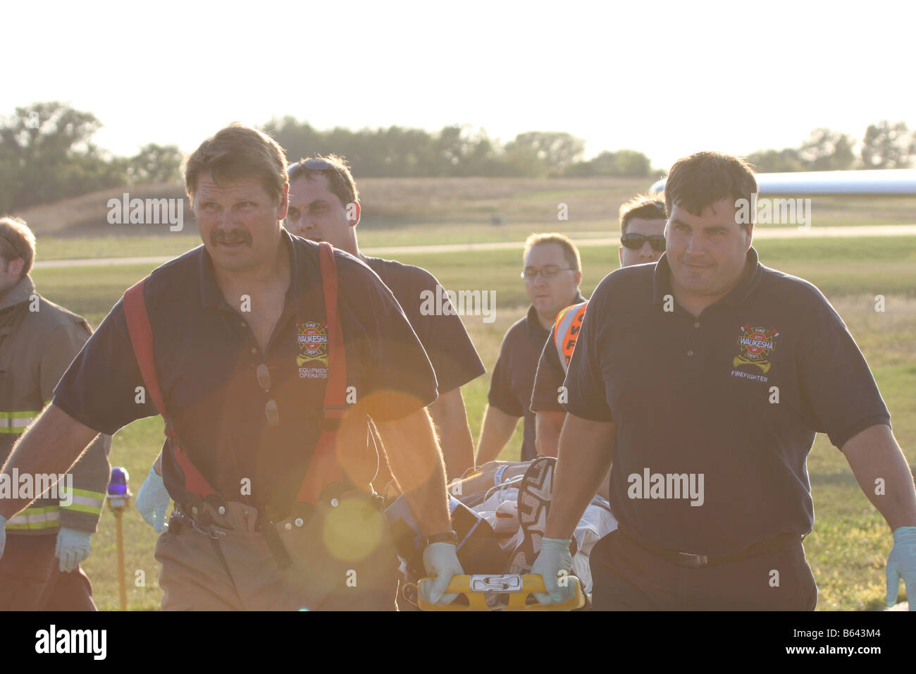 Paramedics carrying a patient a the scene of a mass casualty incident ...