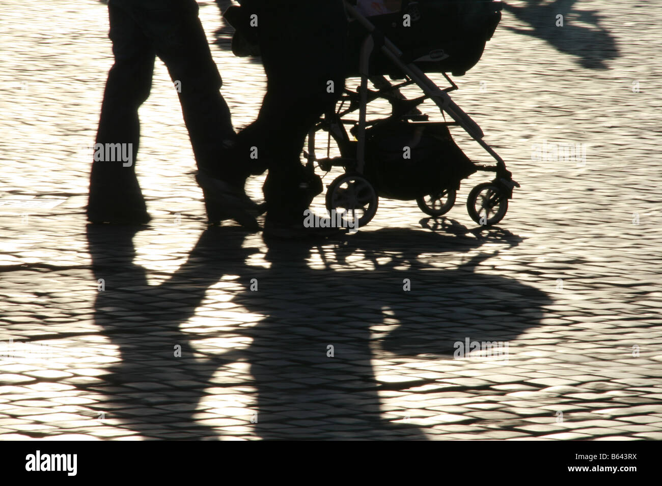 shadow people fast speed feet legs pushing baby pram in sun in street ...