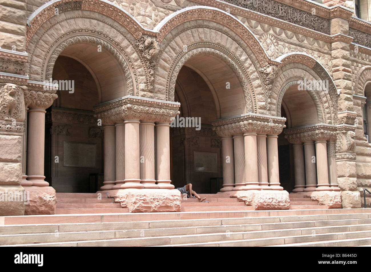 three arched classical architectural building entrance with person ...