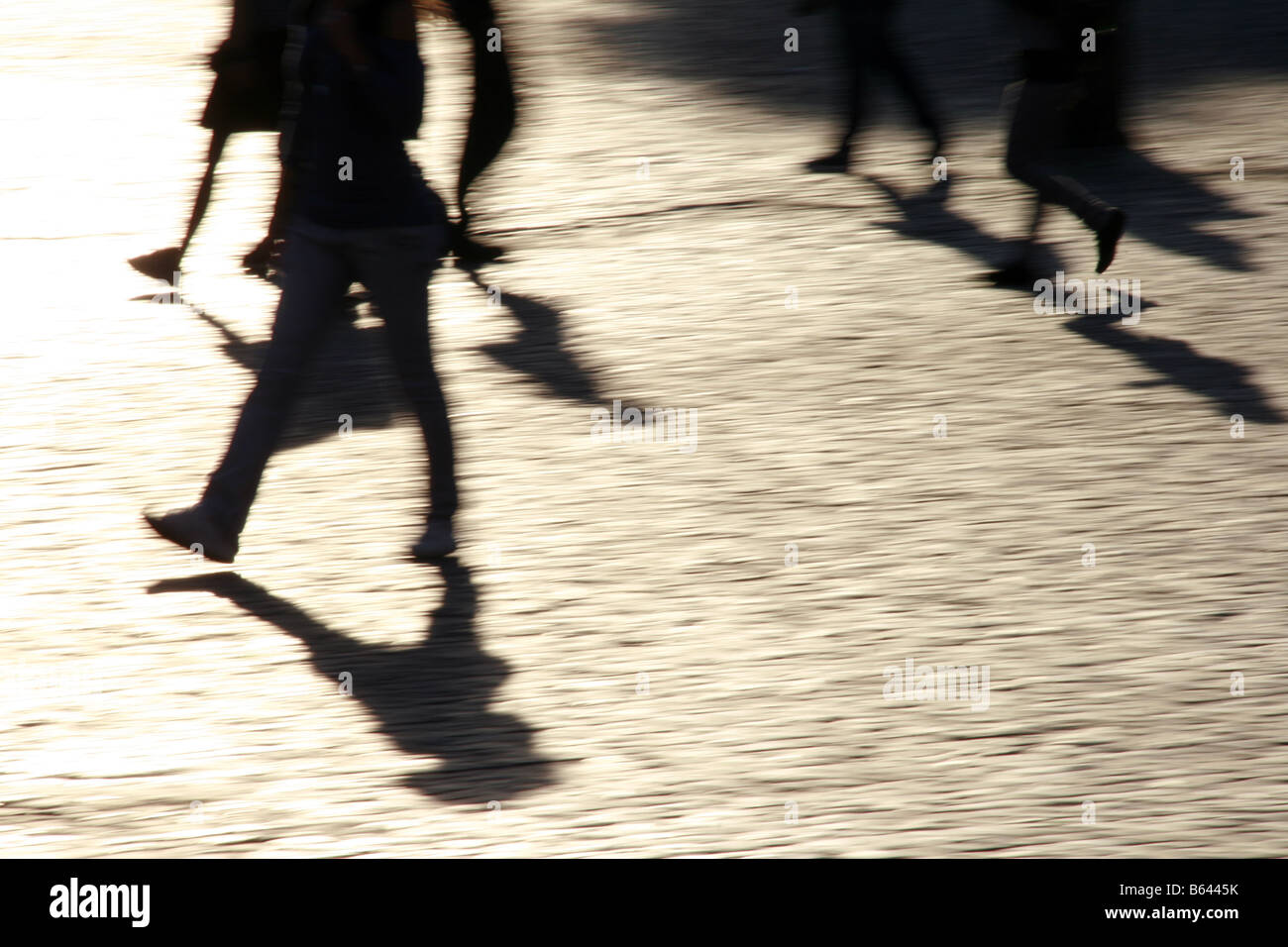 shadow people fast speed feet legs walking in sun in street in town ...
