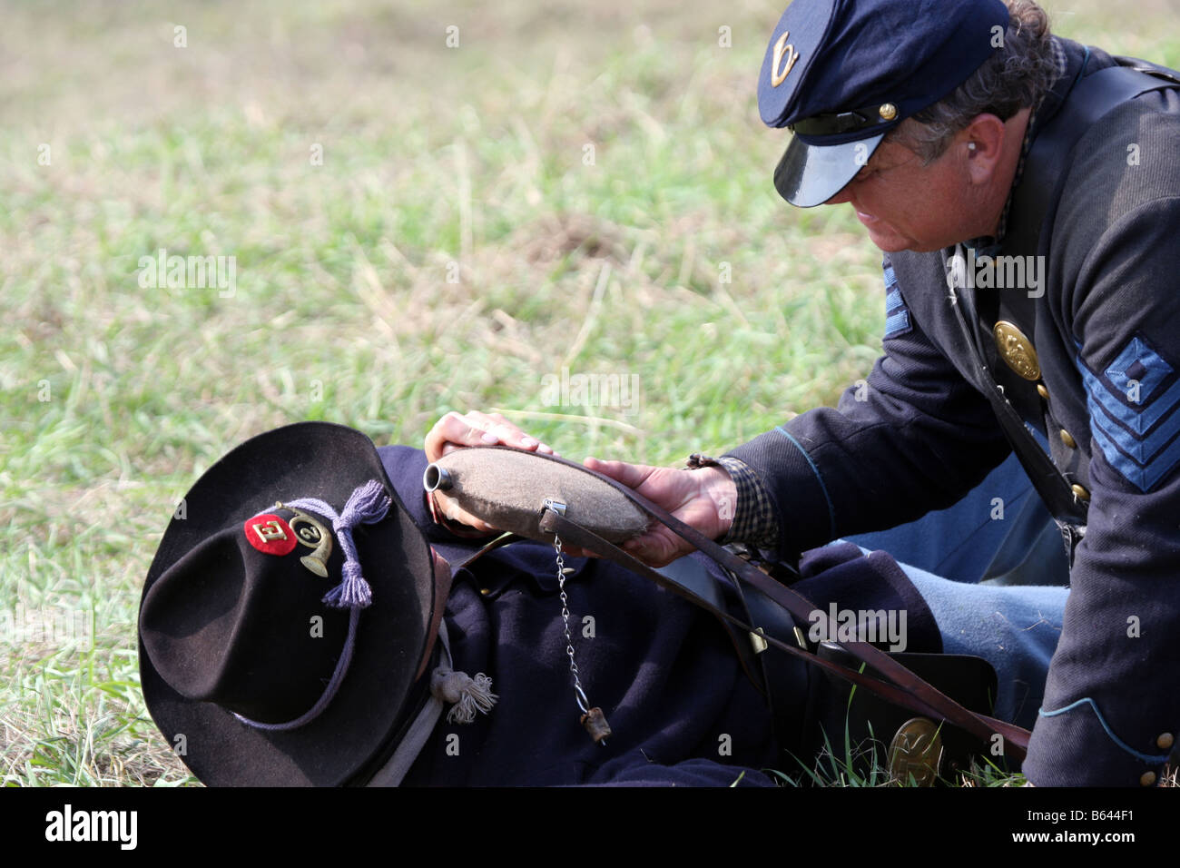 A Union soldier giving water to another soldier injured in battle in ...