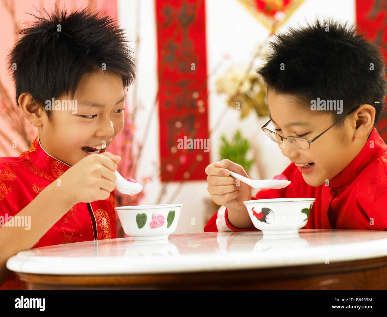 boys eating rice balls celebrating chinese new year Stock Photo - Alamy