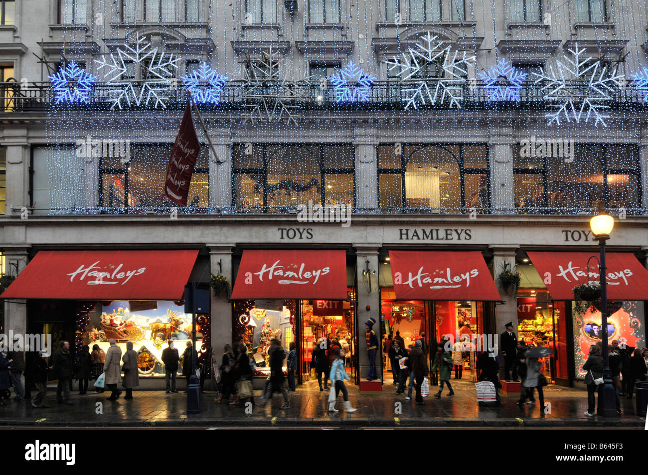Early evening famous Hamleys toy store window display busy shopping ...
