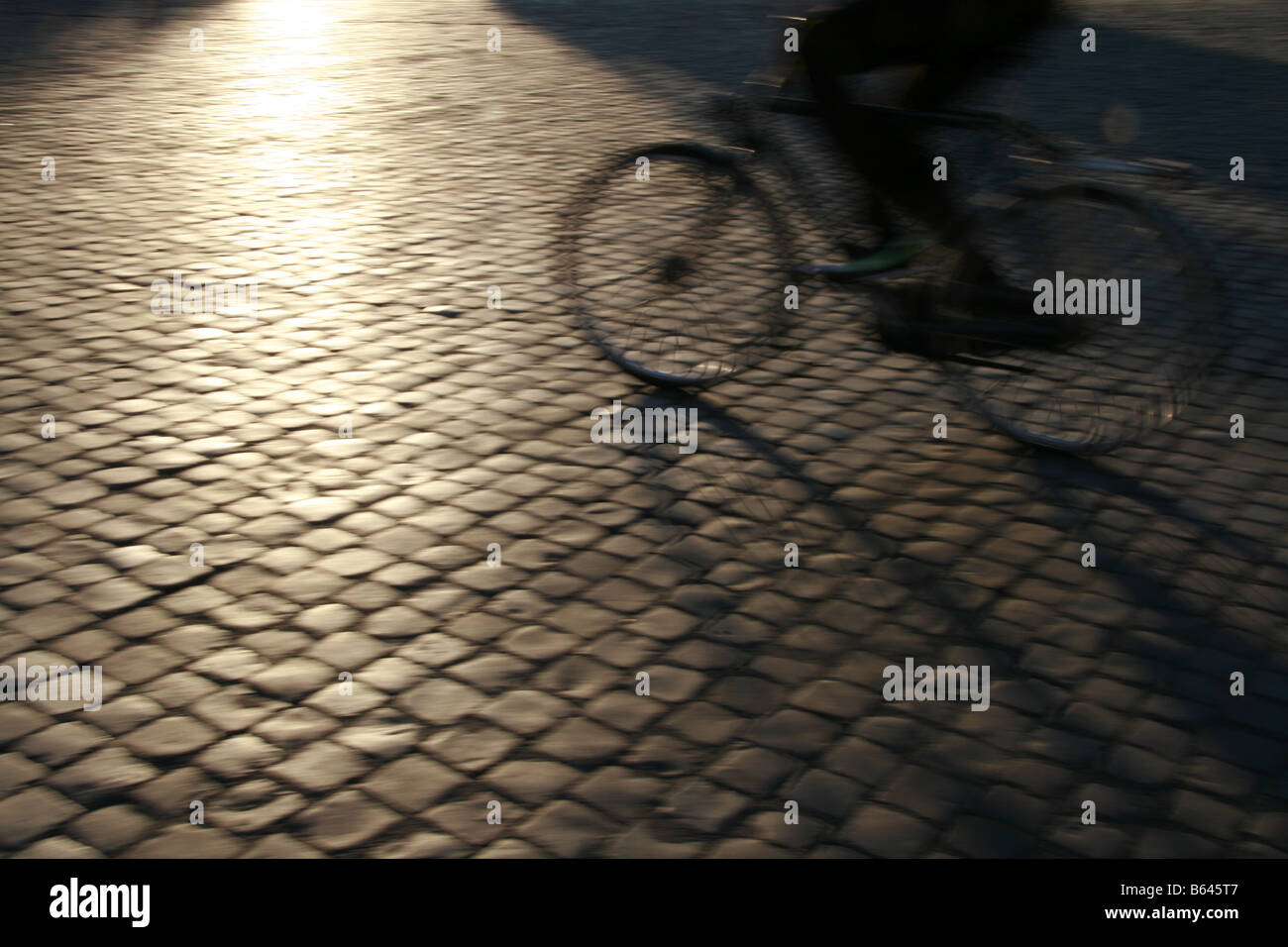shadow fast speed bike in action in sun in street in town Stock Photo ...