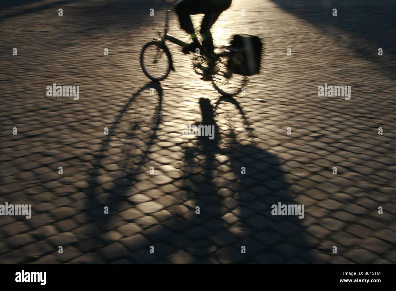 shadow fast speed bike in action in sun in street in town Stock Photo ...