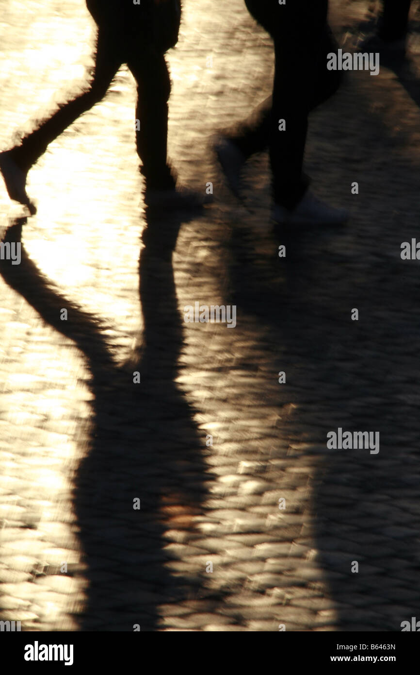 shadow people feet legs walking in street in town Stock Photo - Alamy