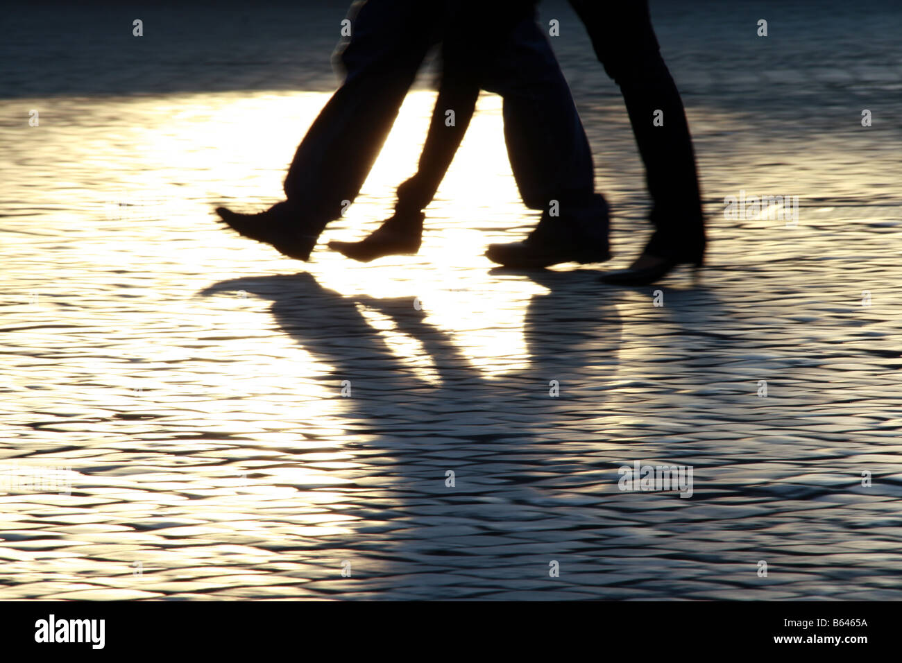 shadow people feet legs walking in street in town Stock Photo - Alamy