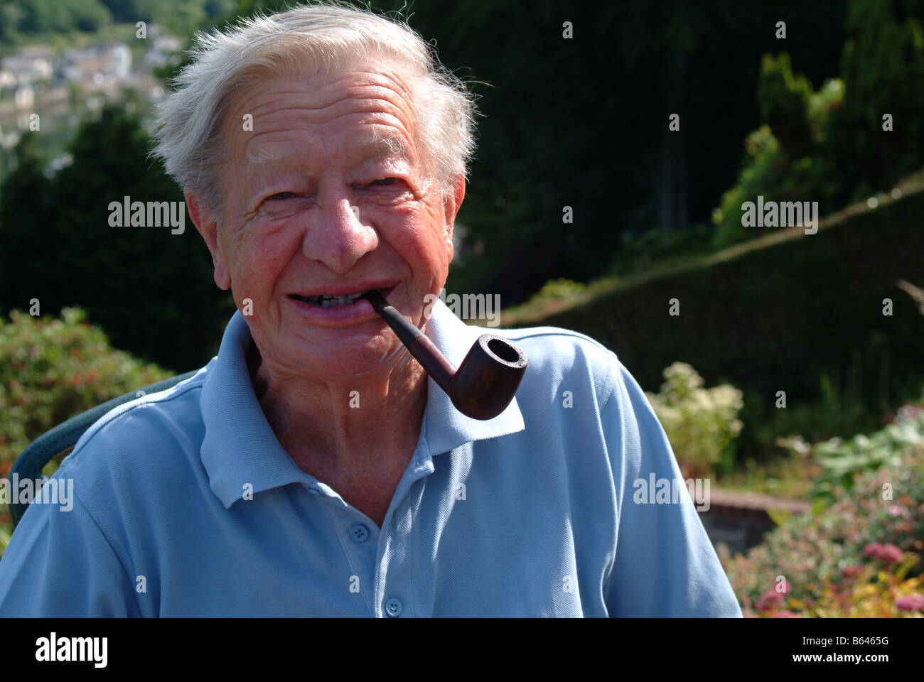 Portrait of a smiling elderly man smoking a pipe Stock Photo - Alamy