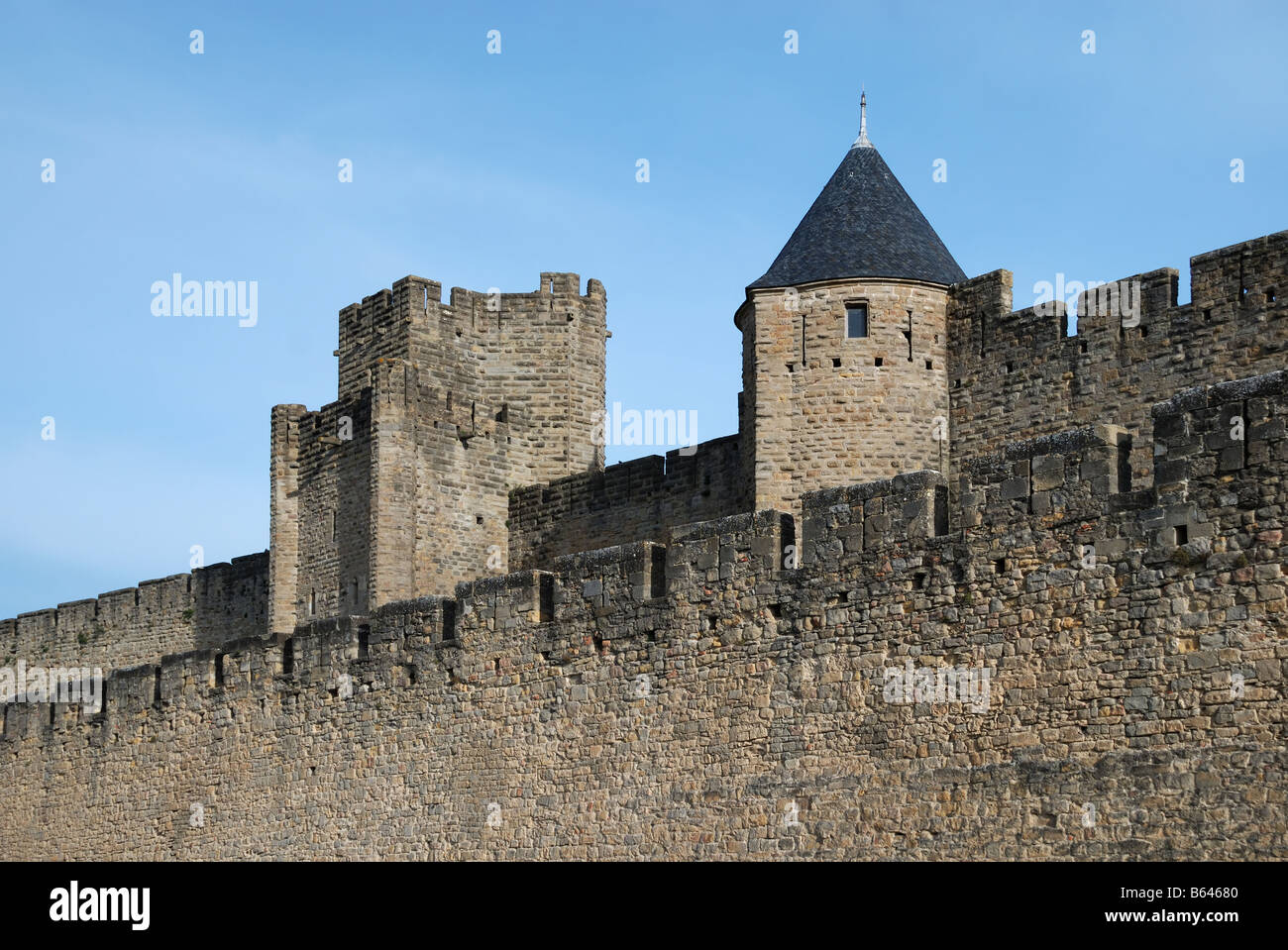 Inner and outer stone walls with towers of Carcasson castle in sunlight ...