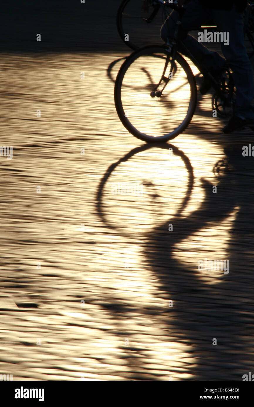 shadow fast speed bike in action in sun in street in town Stock Photo ...