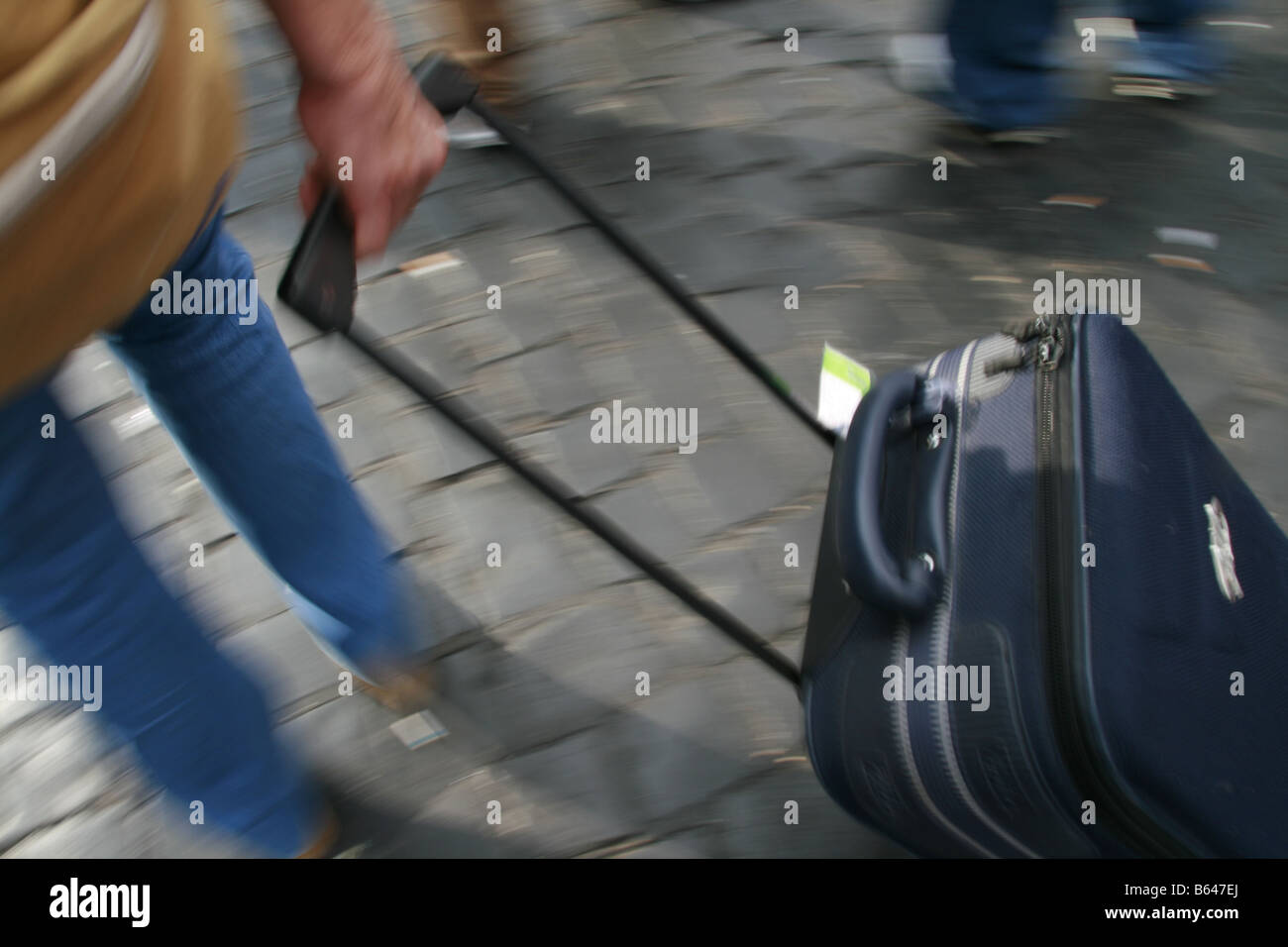 one person in crowd pulling trolley luggage case in town Stock Photo ...