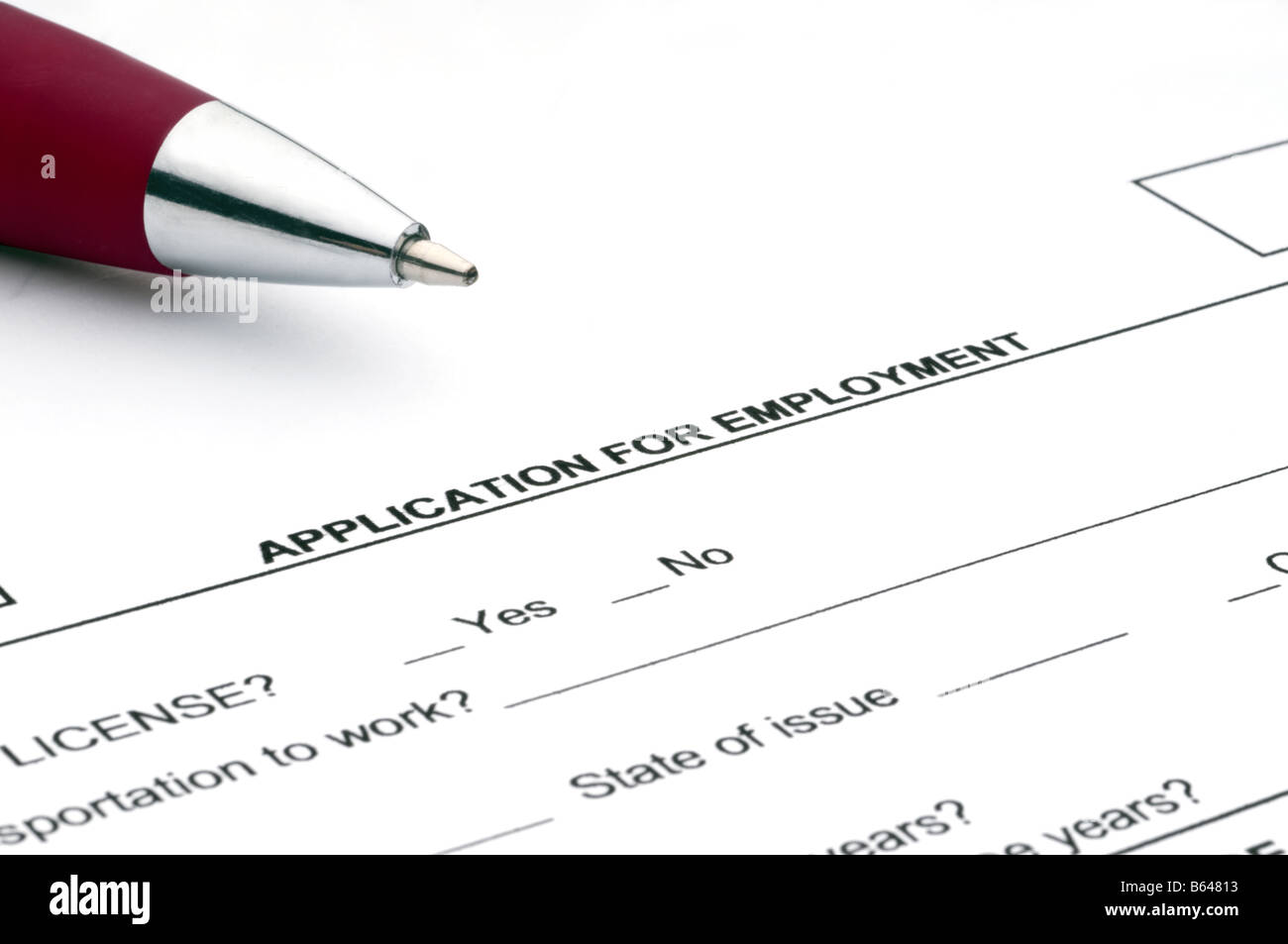 A red pen on a job application Stock Photo - Alamy