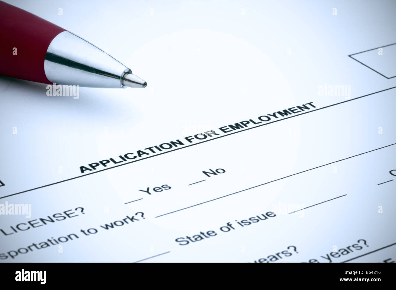 A red pen on a job application with a blue tint Stock Photo - Alamy