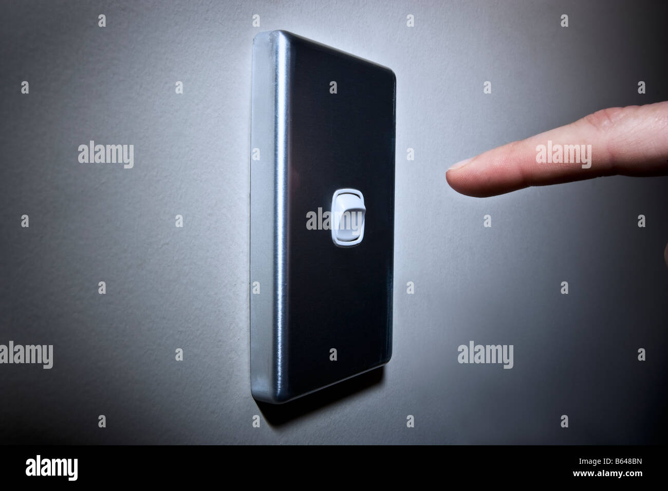 A finger moving towards a light switch Stock Photo - Alamy